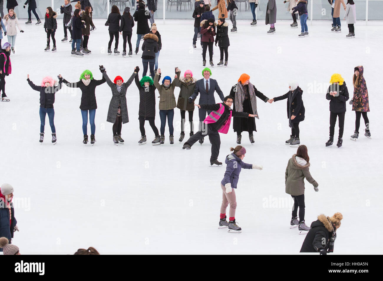 London, UK. Somerset House ice skaters sport colourful wigs created by ...