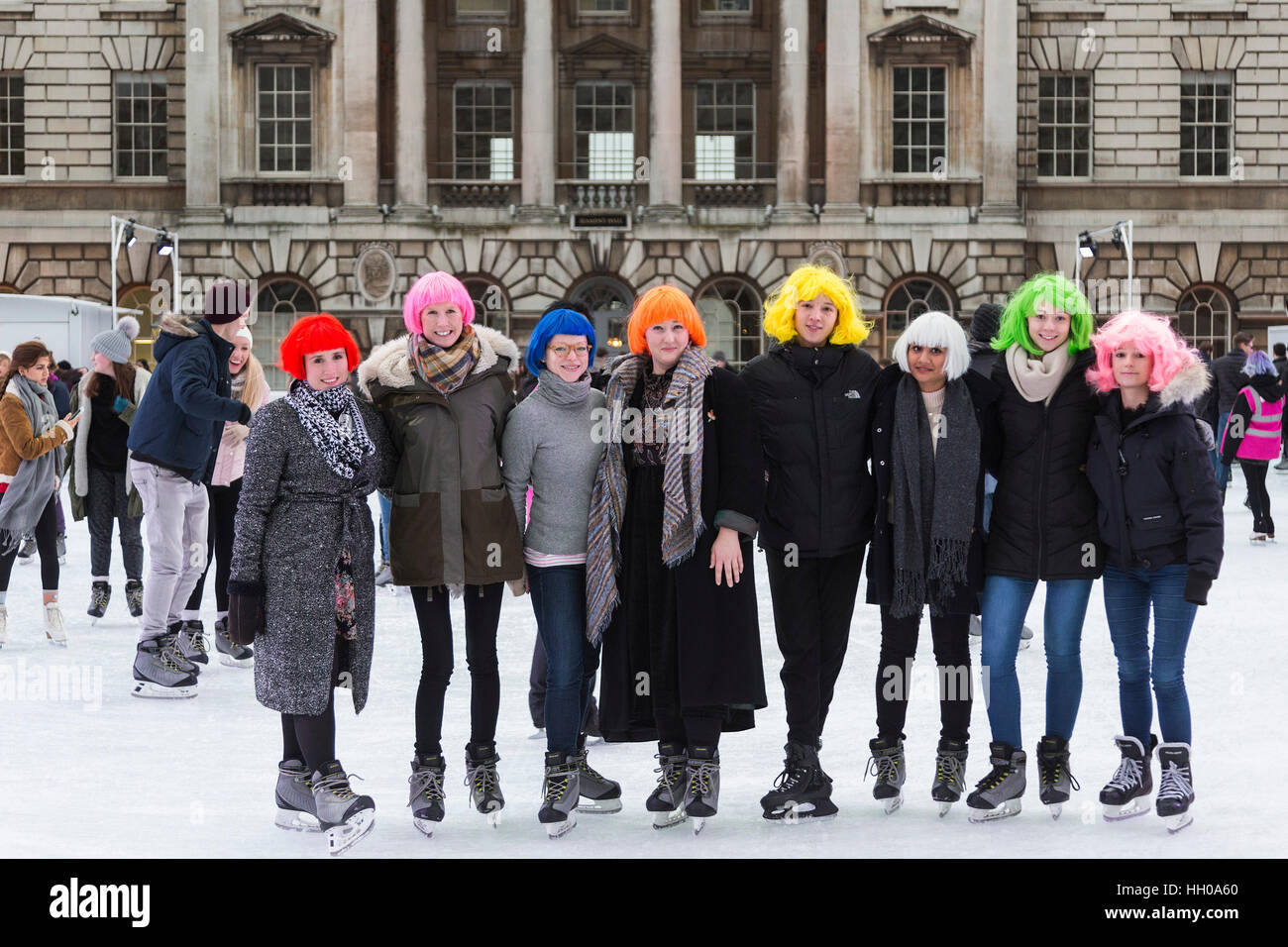 London, UK. Somerset House ice skaters sport colourful wigs created by ...