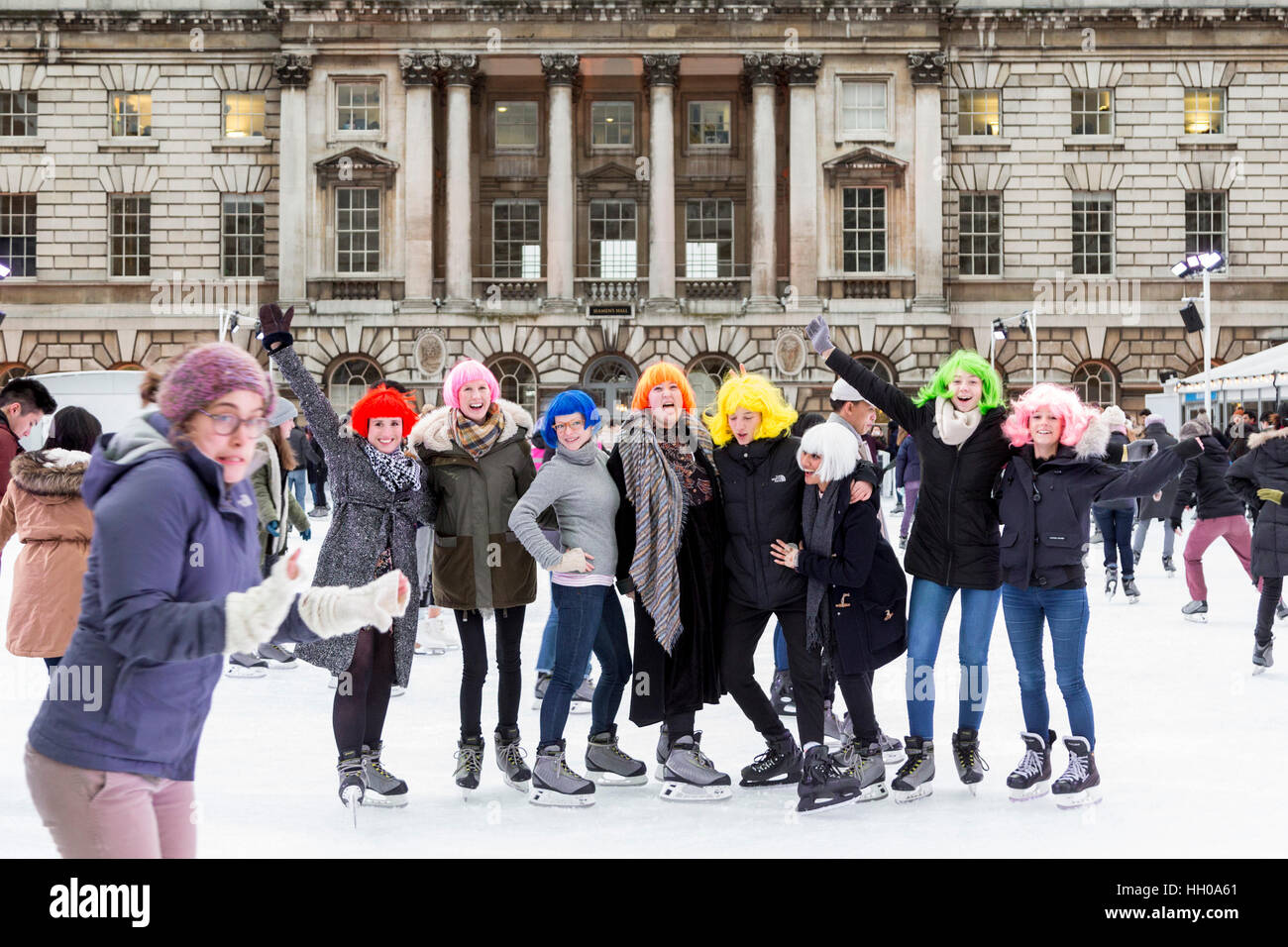 London, UK. Somerset House ice skaters sport colourful wigs created by ...