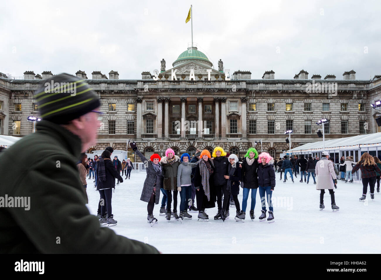 London, UK. Somerset House ice skaters sport colourful wigs created by ...
