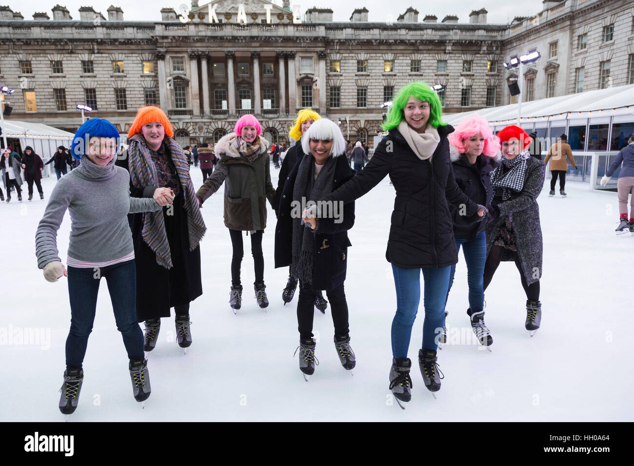 London, UK. Somerset House ice skaters sport colourful wigs created by ...