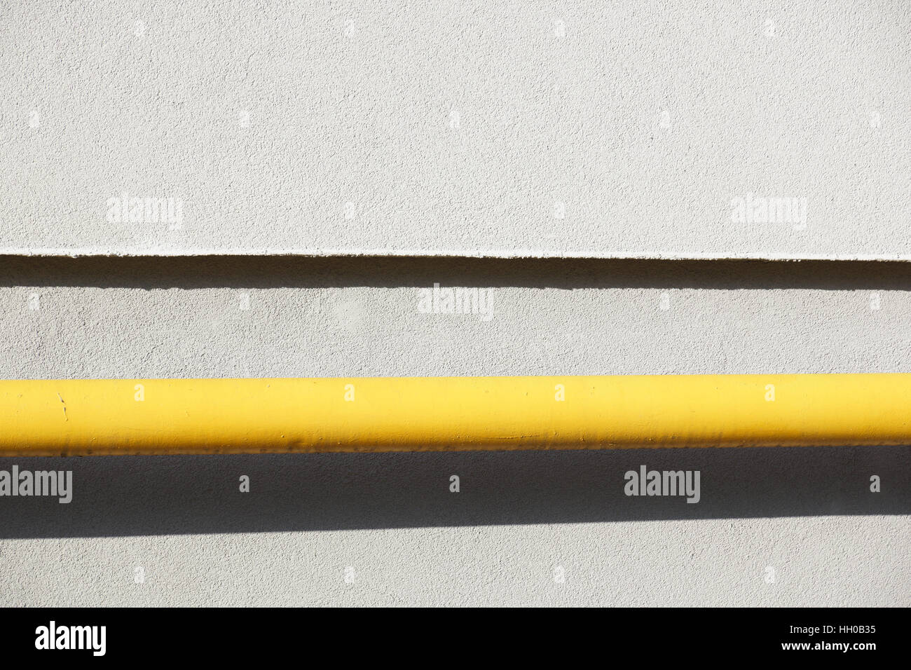 Yellow gas pipe in front of residential building wall Stock Photo - Alamy