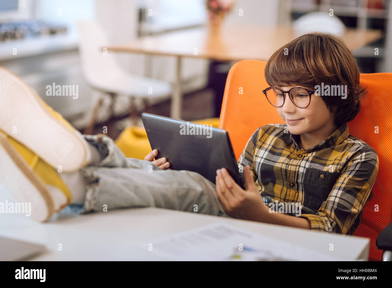 Young person staring into tablet screen Stock Photo - Alamy