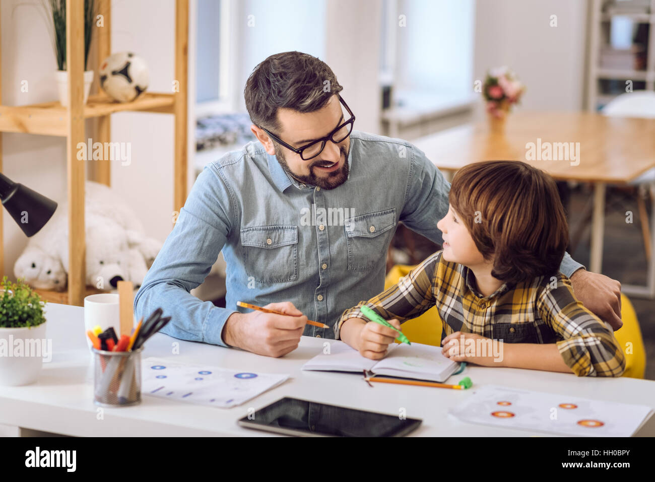 Handsome man doing tasks with his son Stock Photo - Alamy