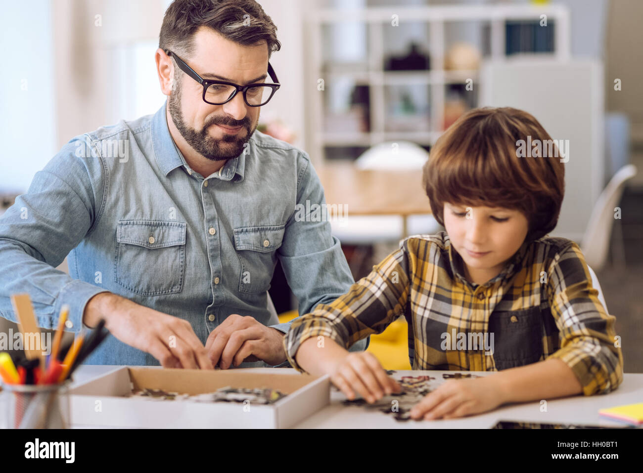 Two best friends playing with puzzles Stock Photo - Alamy