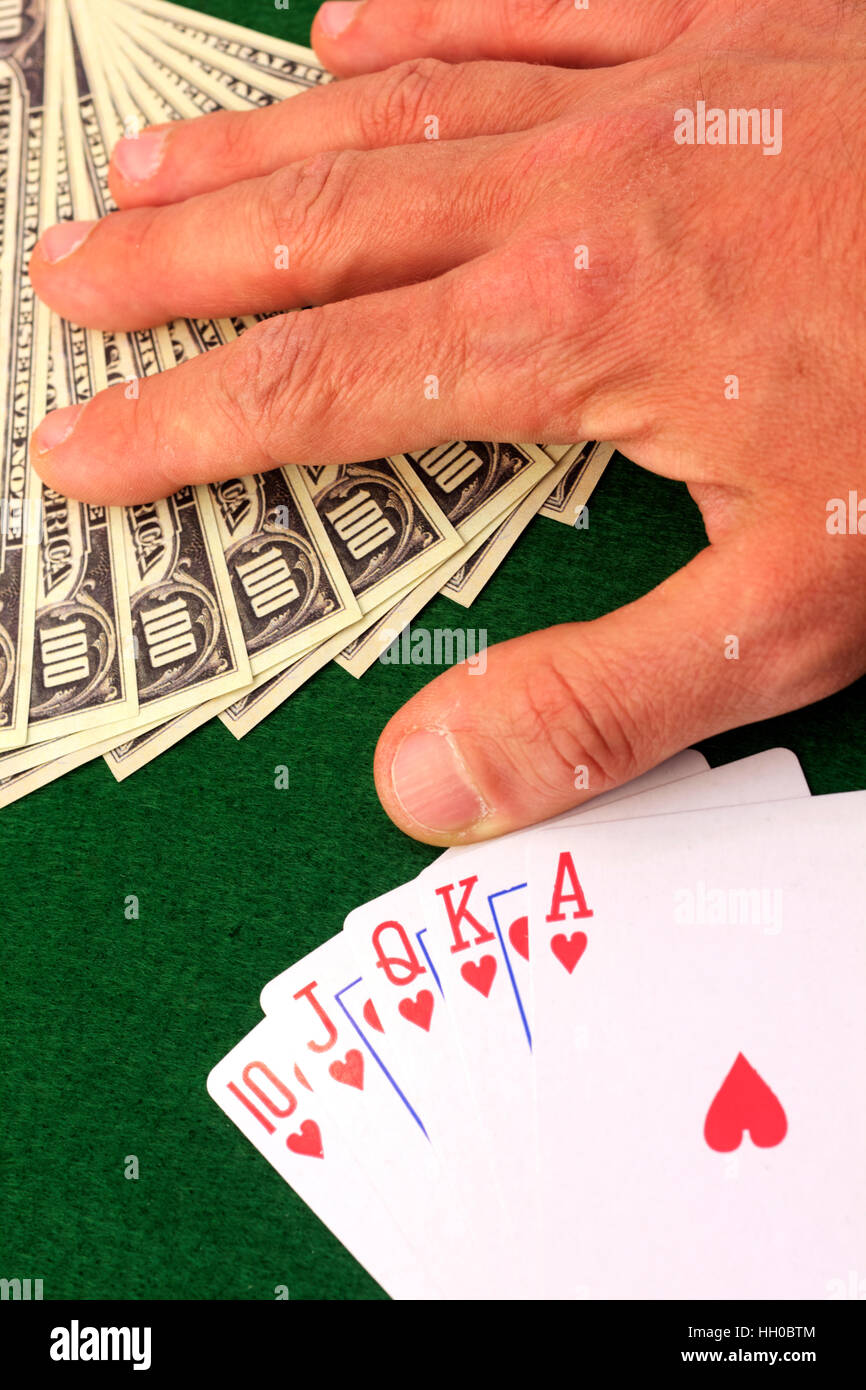 Playing cards and money on green background closeup Stock Photo - Alamy