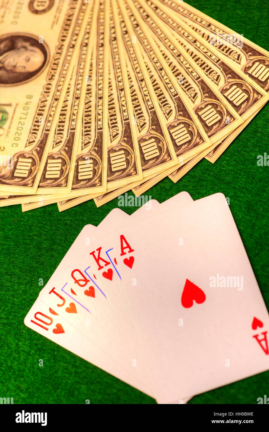Playing cards and money on green background closeup Stock Photo - Alamy