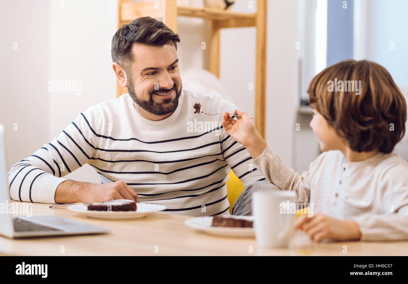 Happy smiling family eating together Stock Photo - Alamy