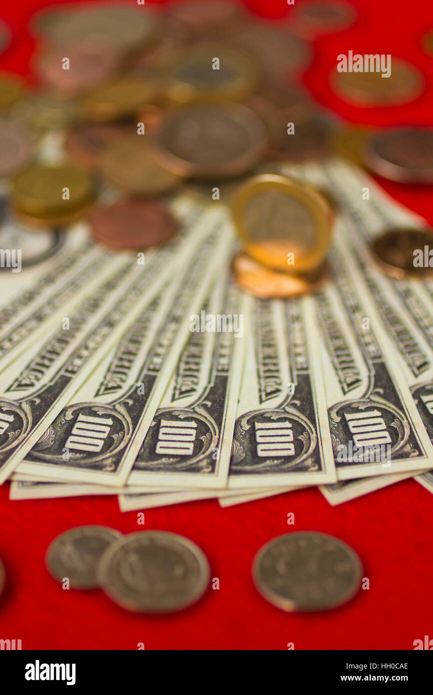 Money on red background closeup Stock Photo - Alamy