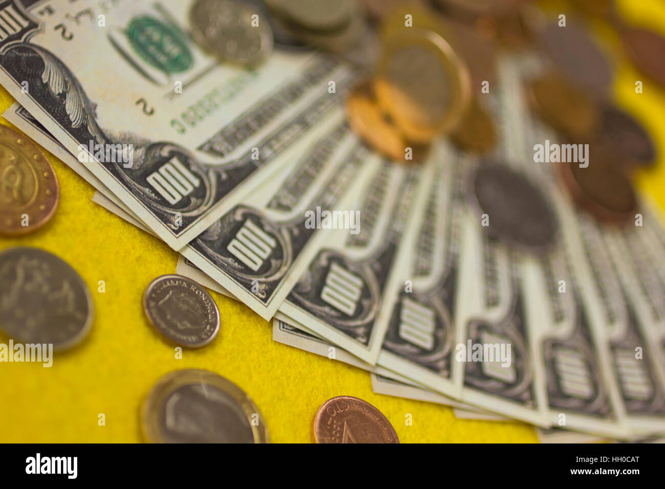 Money on yellow background closeup Stock Photo - Alamy