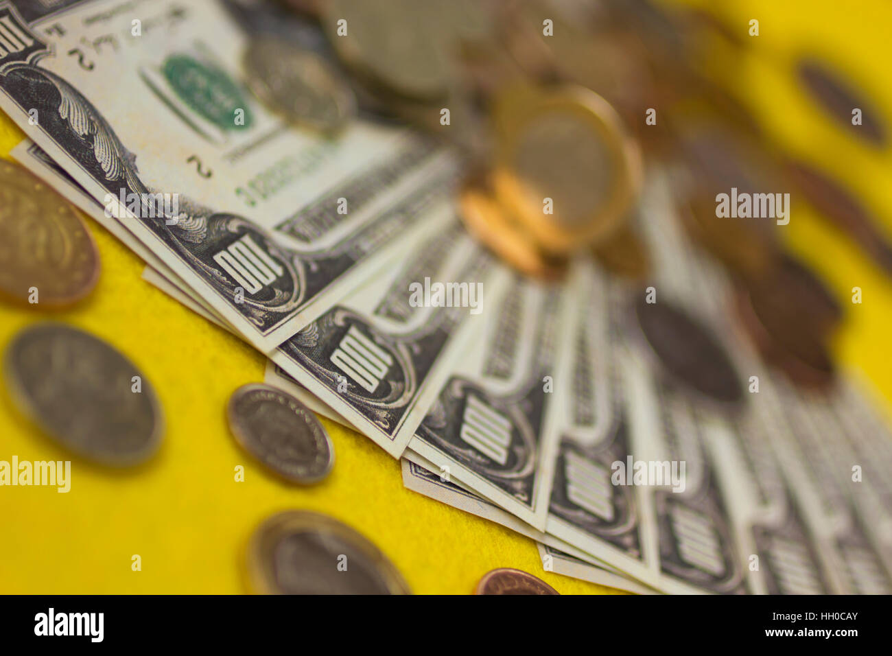 Money on yellow background closeup Stock Photo - Alamy