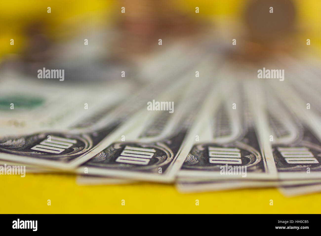 Money on yellow background closeup Stock Photo - Alamy