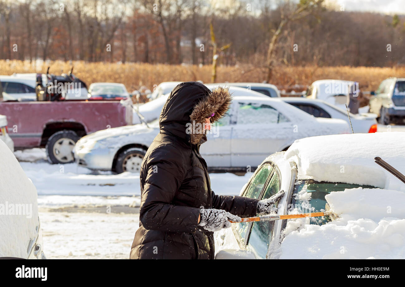 Beautiful woman cleans snow from hi-res stock photography and images ...