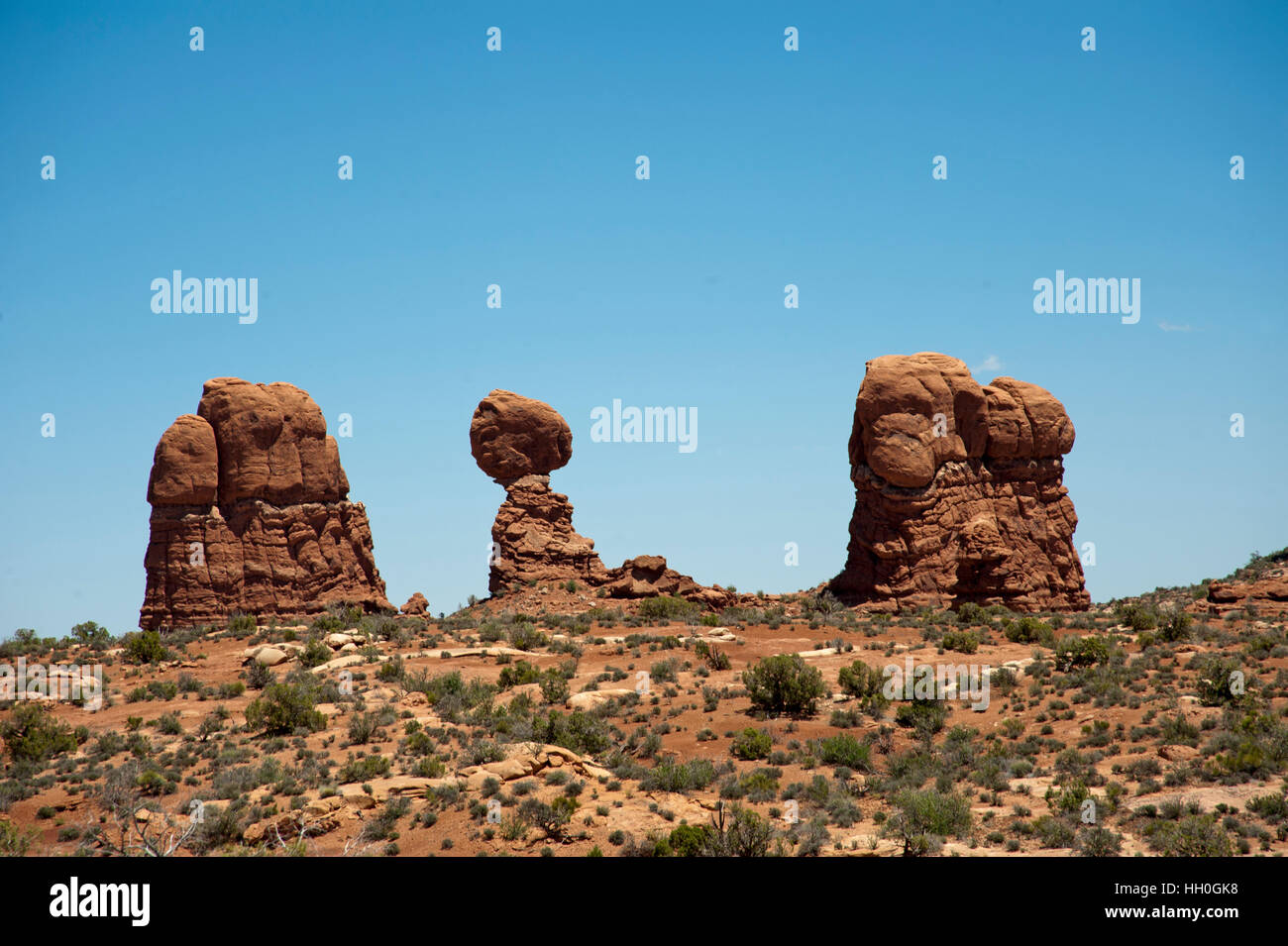 Wide shot of balanced rock and red rock formations framing the rock ...