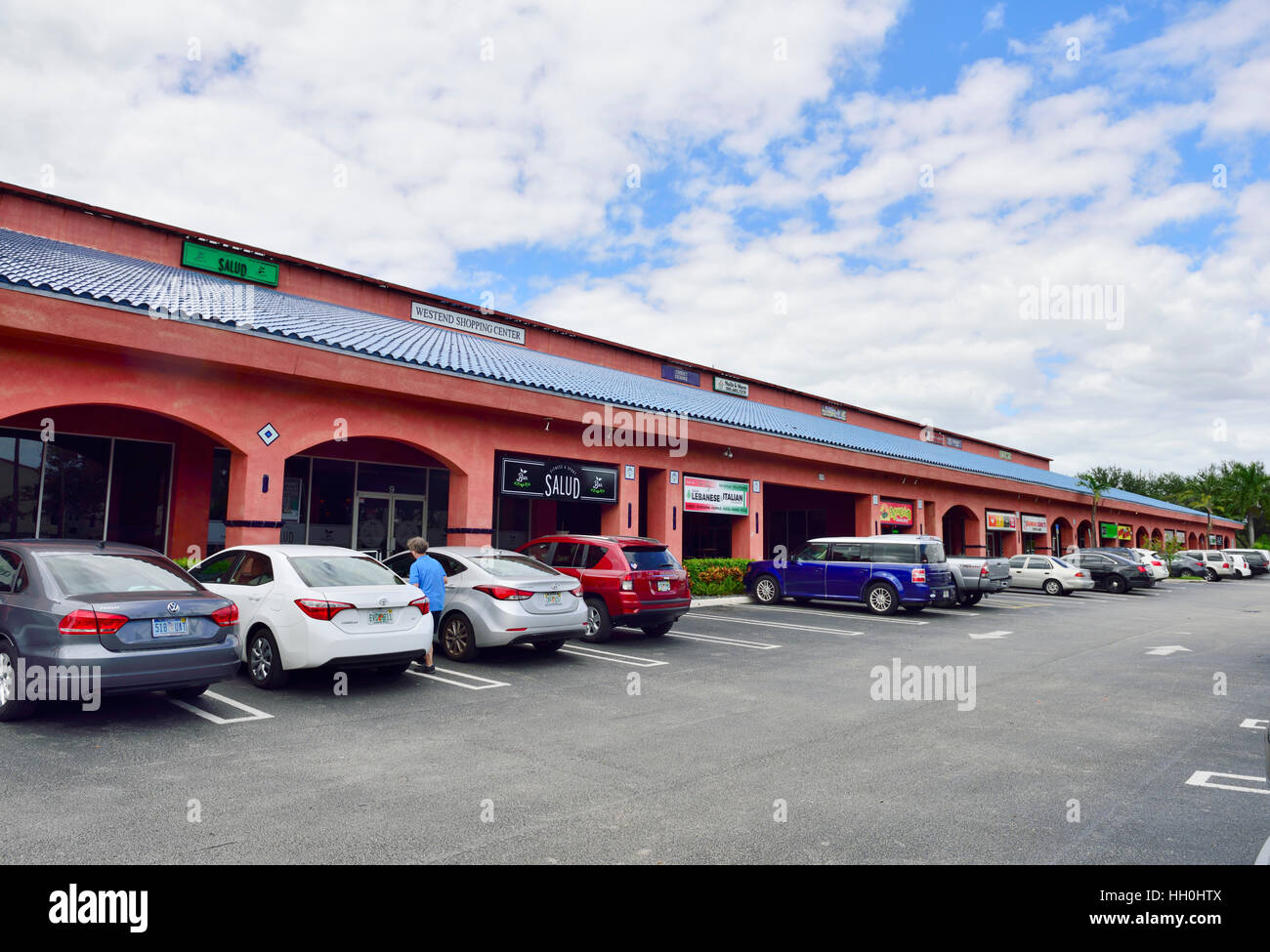 Small local shopping centre as a long strip with small businesses in ...