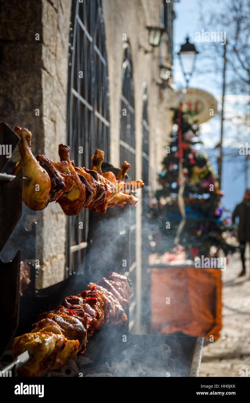 Roast chicken and pork (Kontosouvli) on the rotisserie and grill with ...