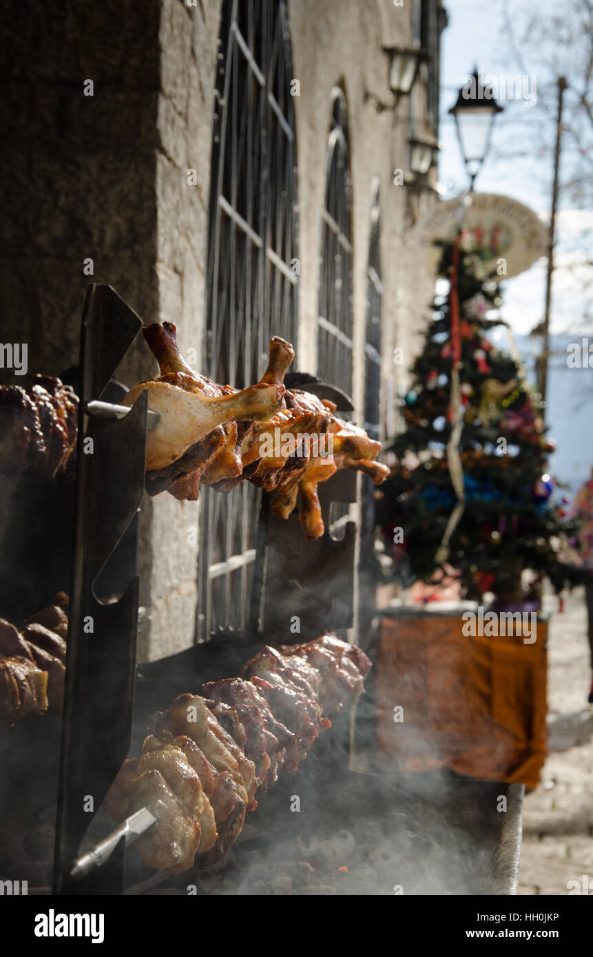Roast chicken and pork (Kontosouvli) on the rotisserie and grill with ...