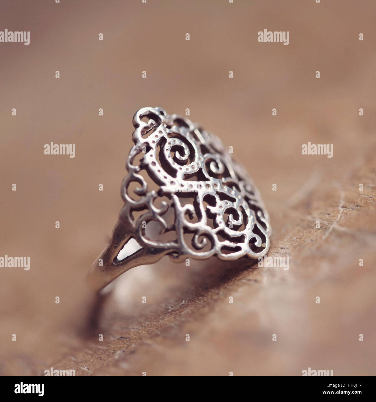 Ornamental vintage ring on wooden table Stock Photo - Alamy