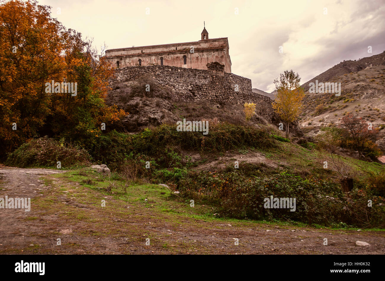 Medieval monastery on the hill for ancient stone wall in the autumn ...