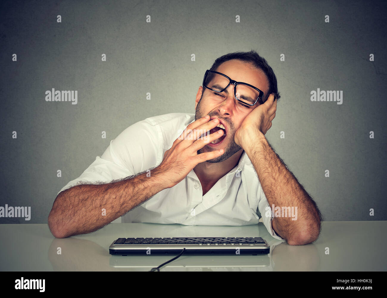 Sleepy man working on computer hi-res stock photography and images - Alamy