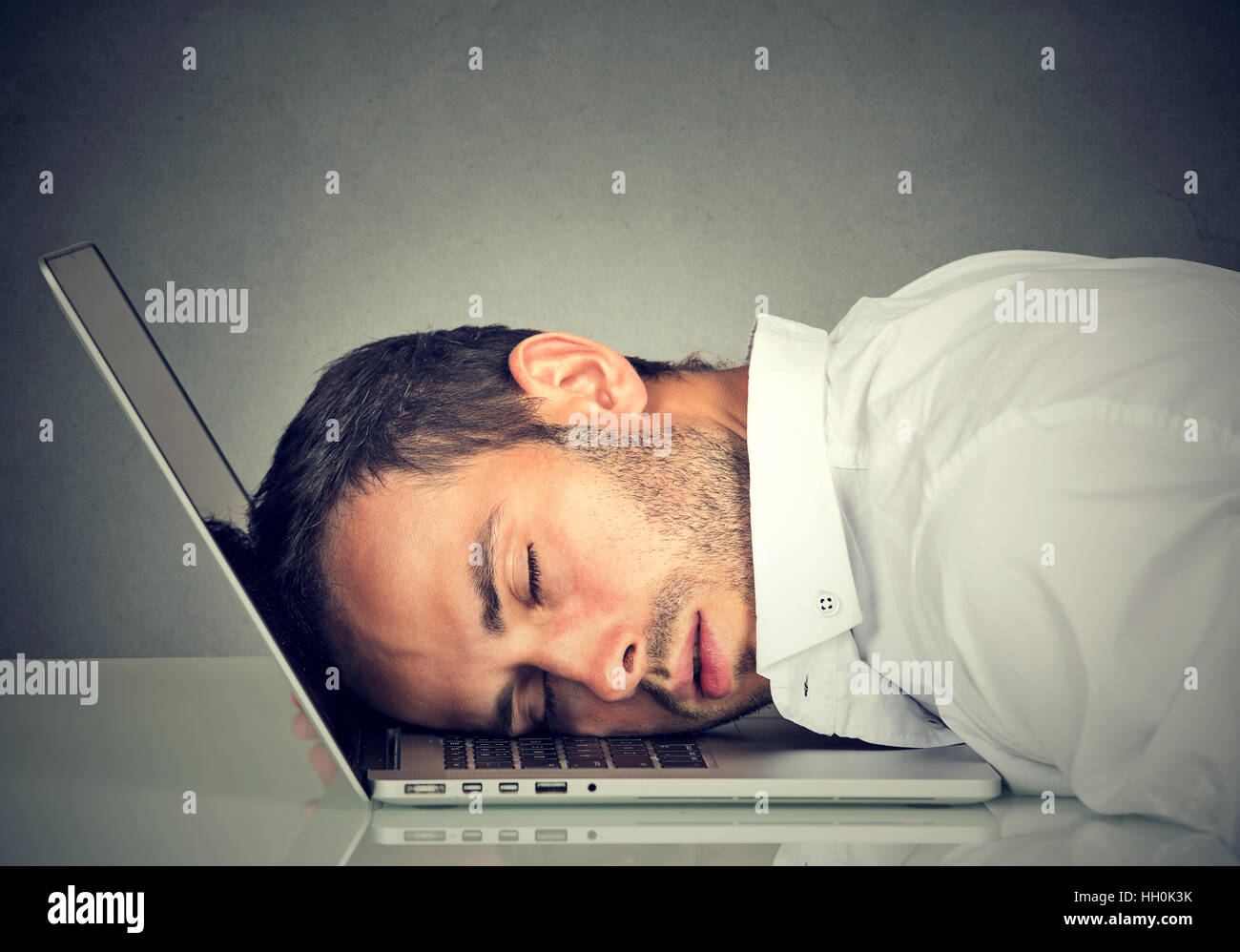 Business man sleeping on his laptop in his office Stock Photo - Alamy