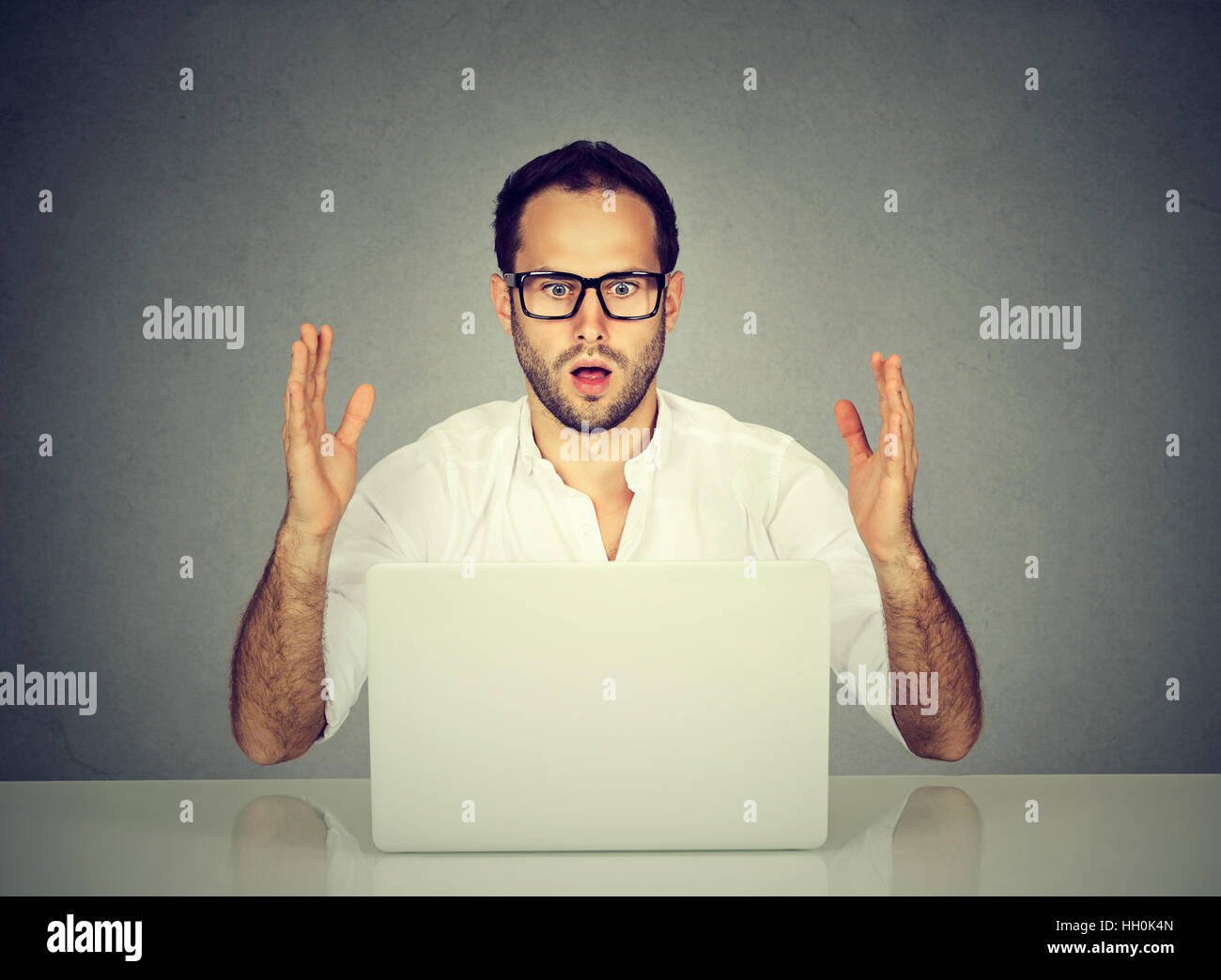 Stressed man looking at his laptop computer Stock Photo - Alamy