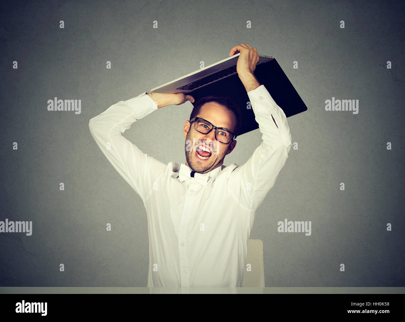 Angry man about to throw laptop hi-res stock photography and images - Alamy