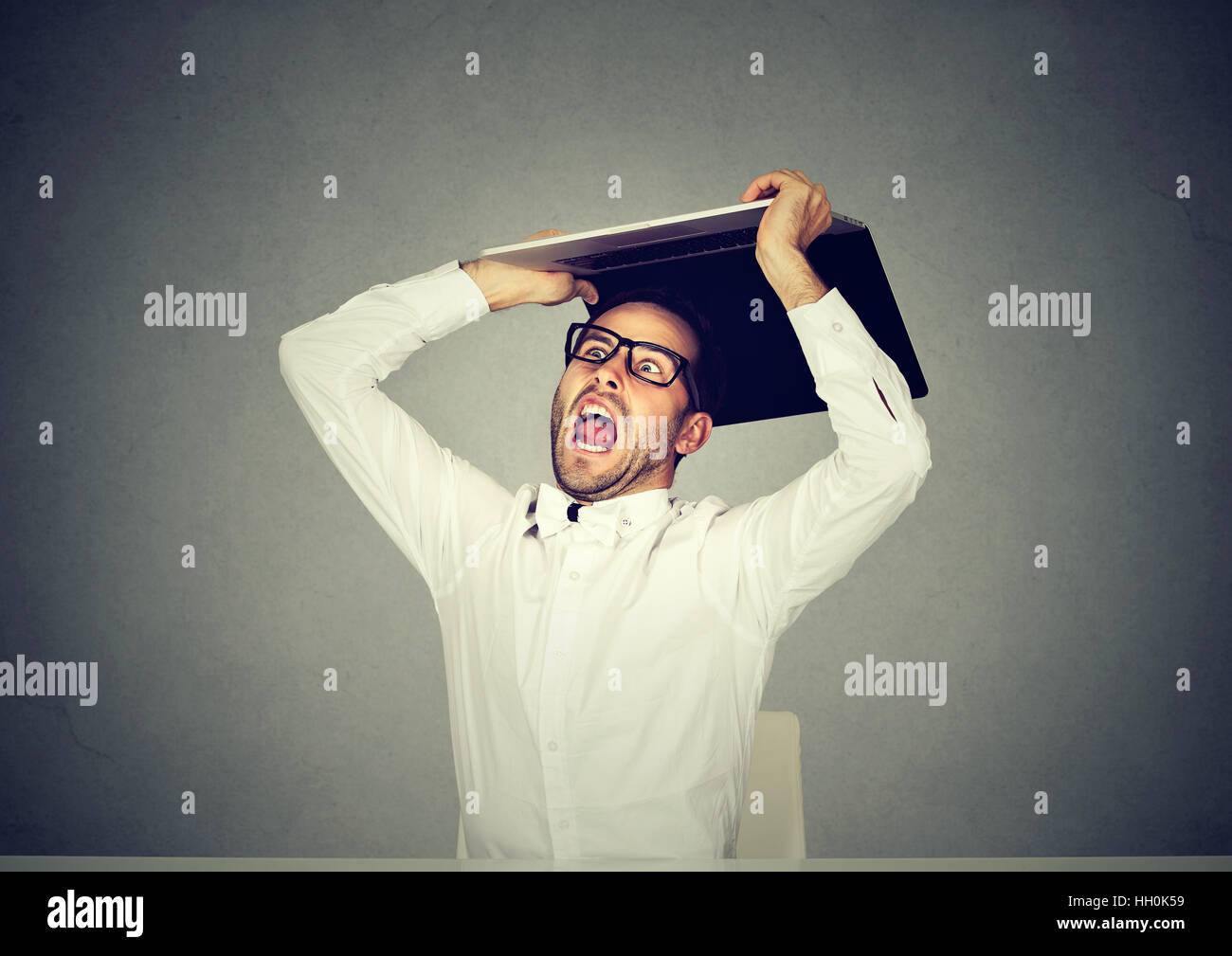 Angry man about to throw laptop hi-res stock photography and images - Alamy