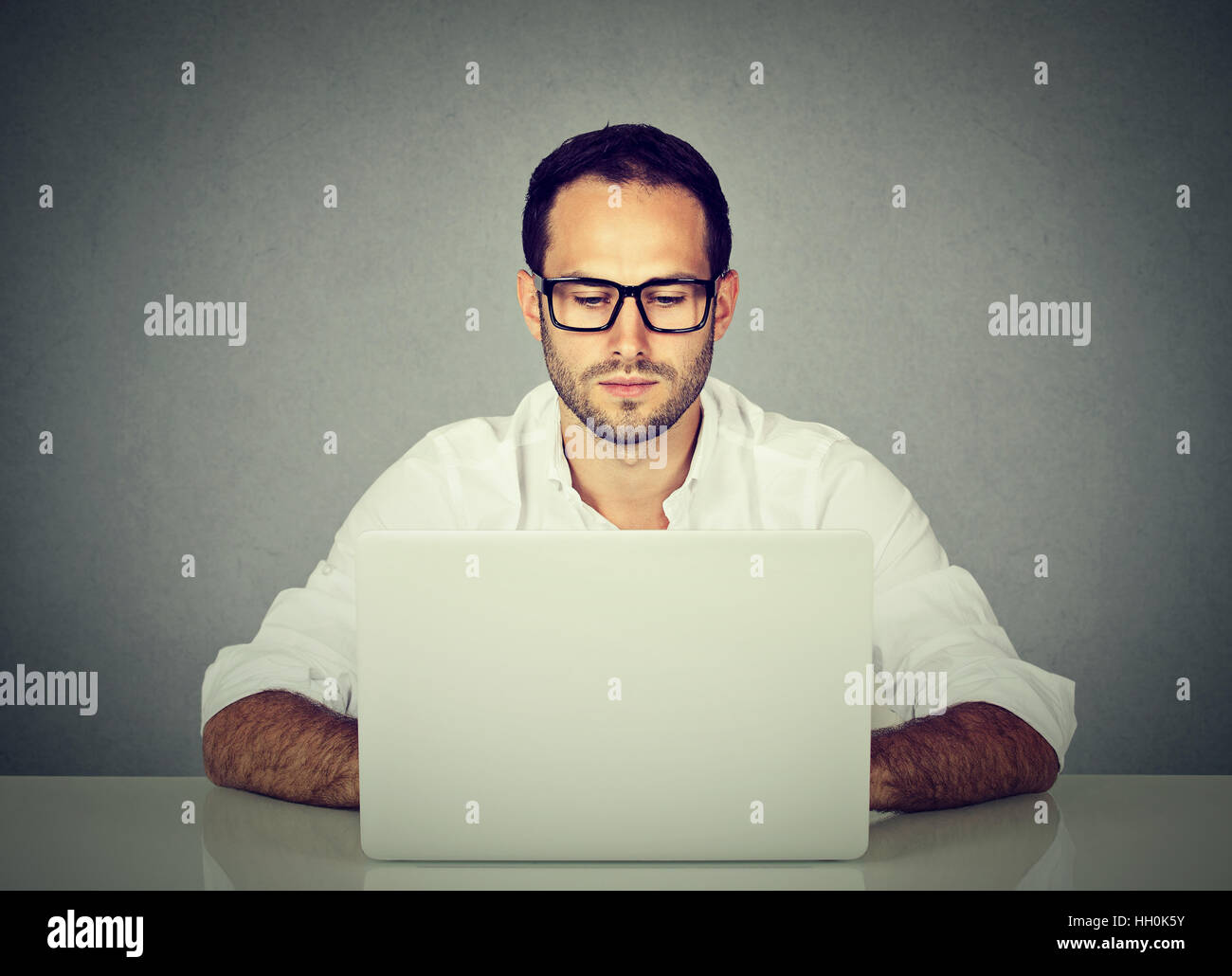 Young man using a laptop computer Stock Photo - Alamy