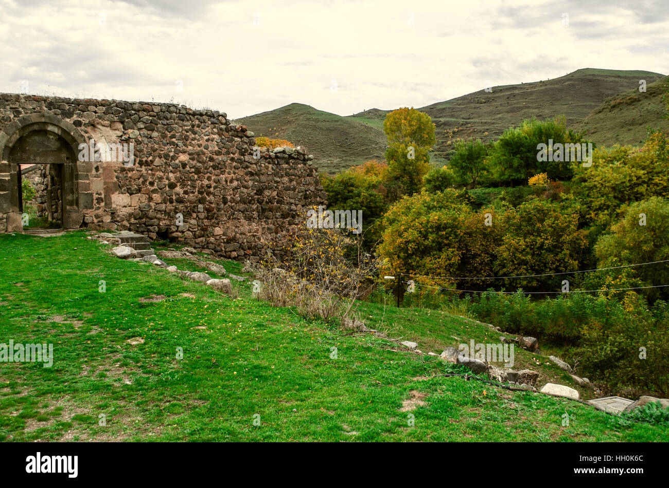 Entrance to the stone wall medieval monastery Stock Photo - Alamy