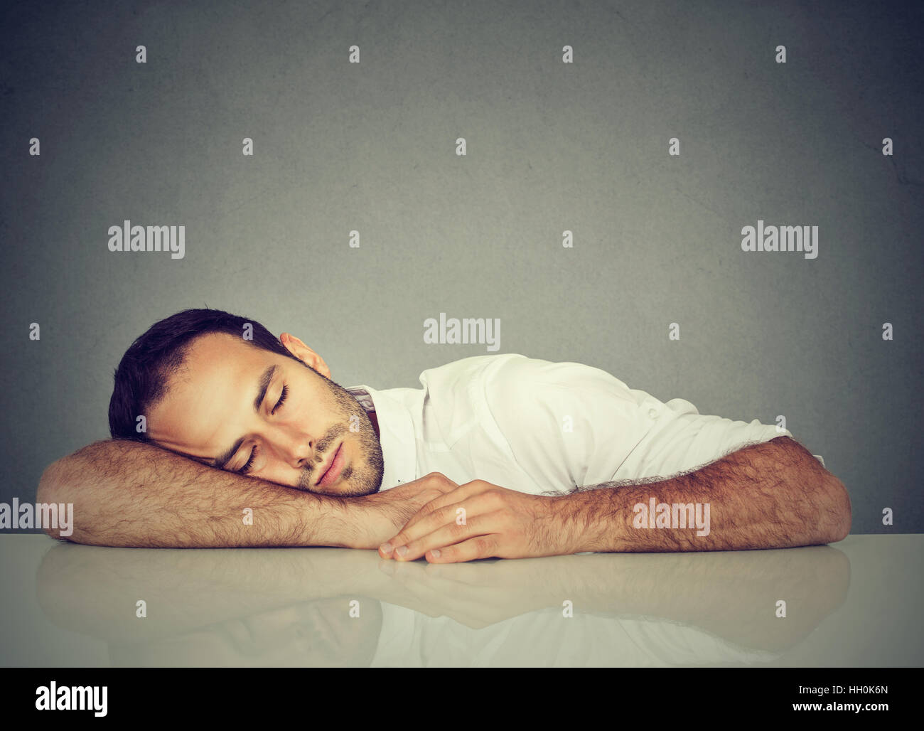 Man sleeping on a desk Stock Photo - Alamy