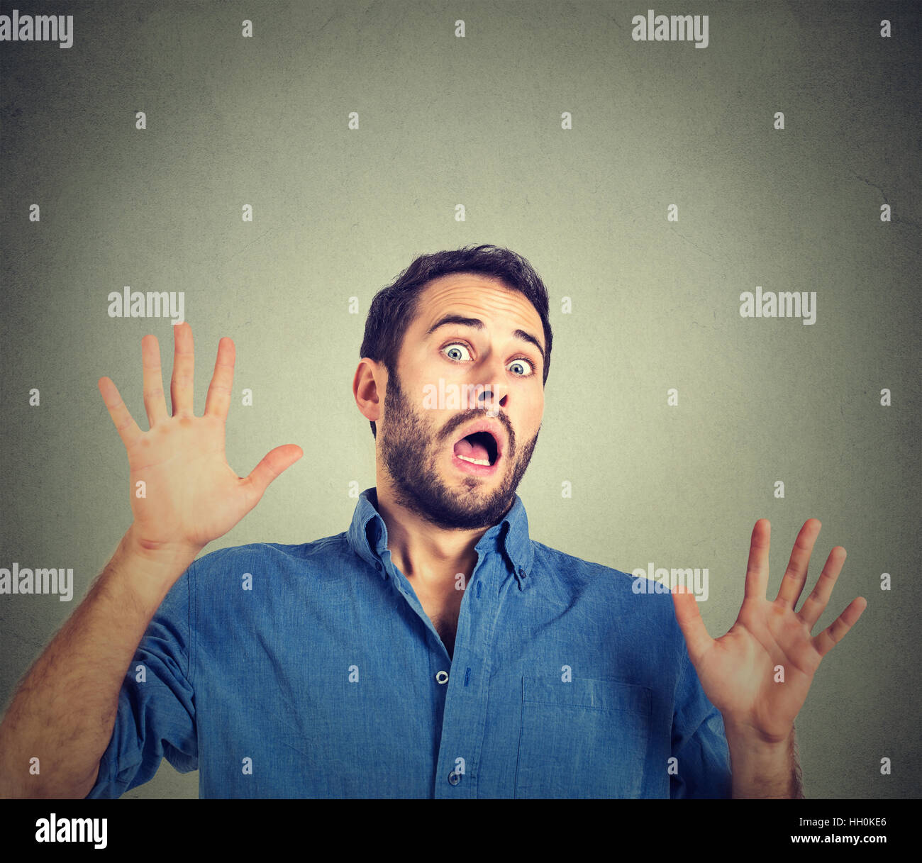 scared man on gray wall background Stock Photo - Alamy