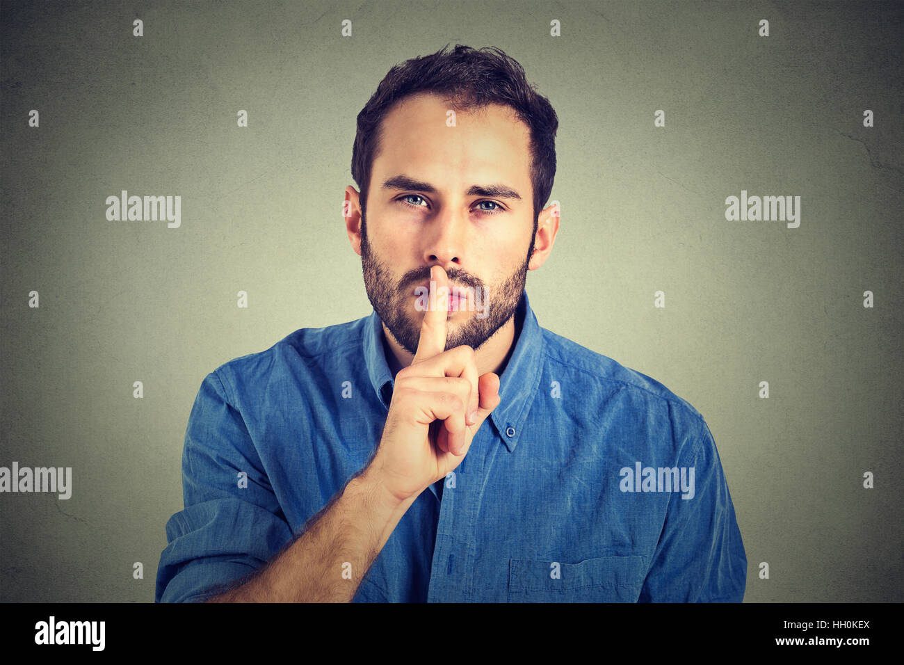 Handsome businessman gesture shhh secret hi-res stock photography and ...
