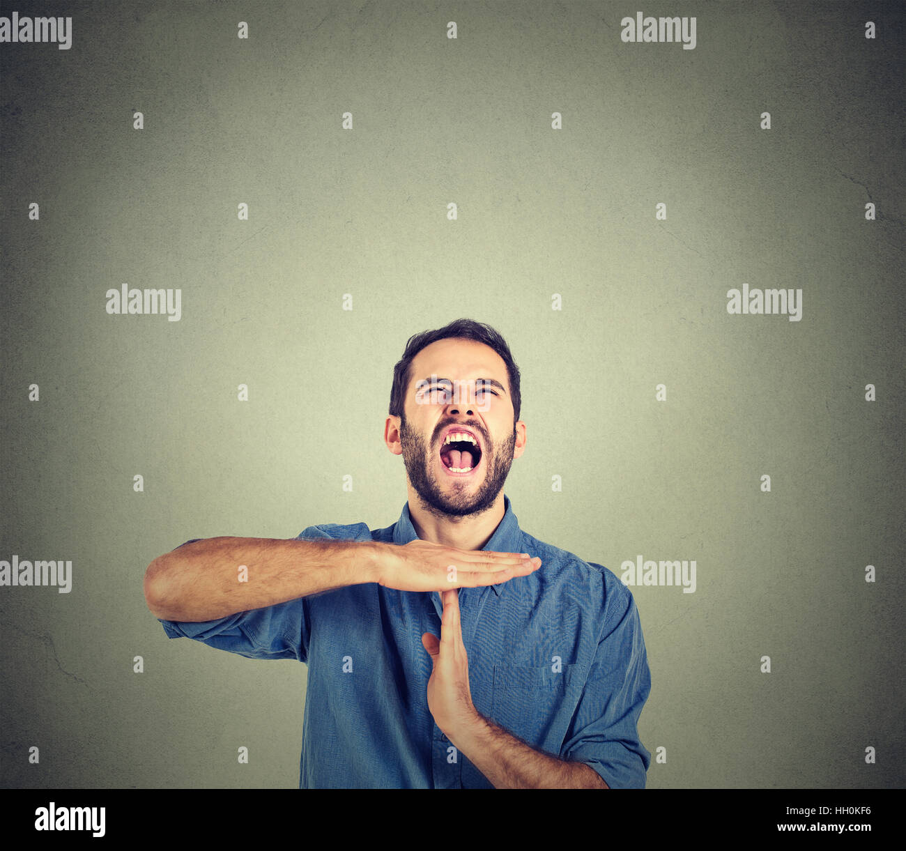 man showing time out hand gesture, frustrated screaming to stop ...