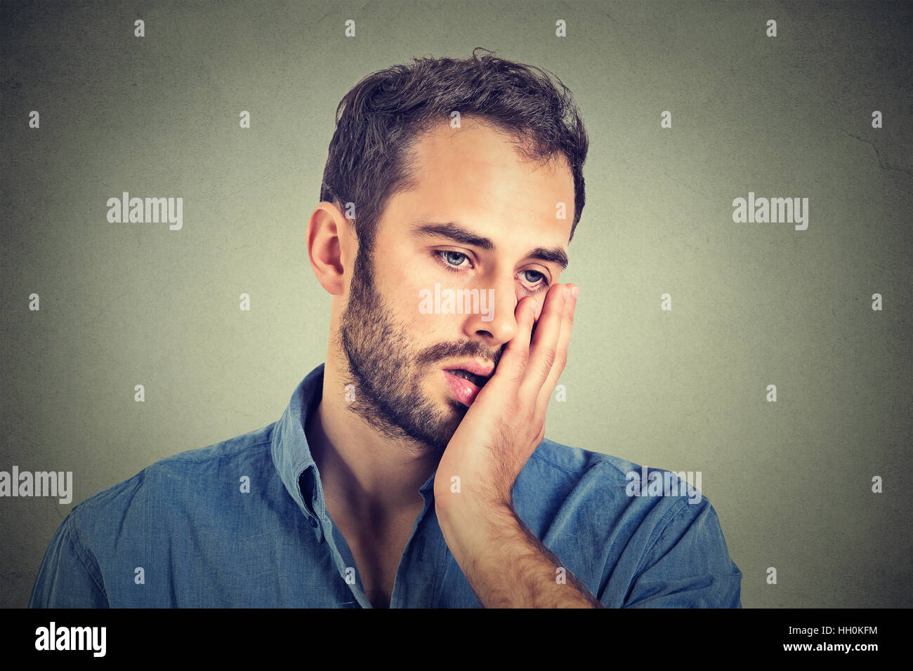 portrait of desperate unhappy man isolated on gray wall background ...