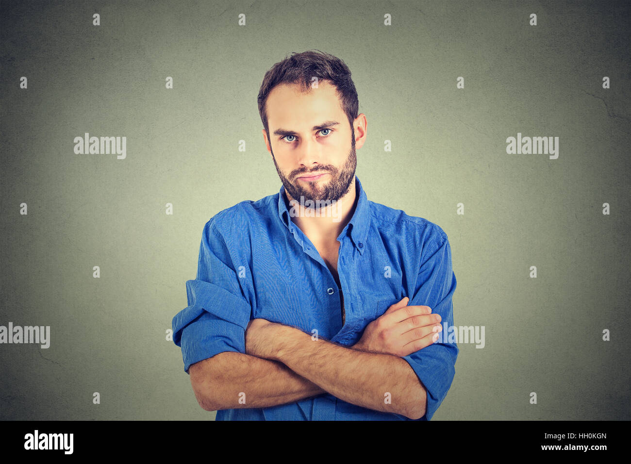 angry grumpy man looking very displeased isolated on gray wall ...