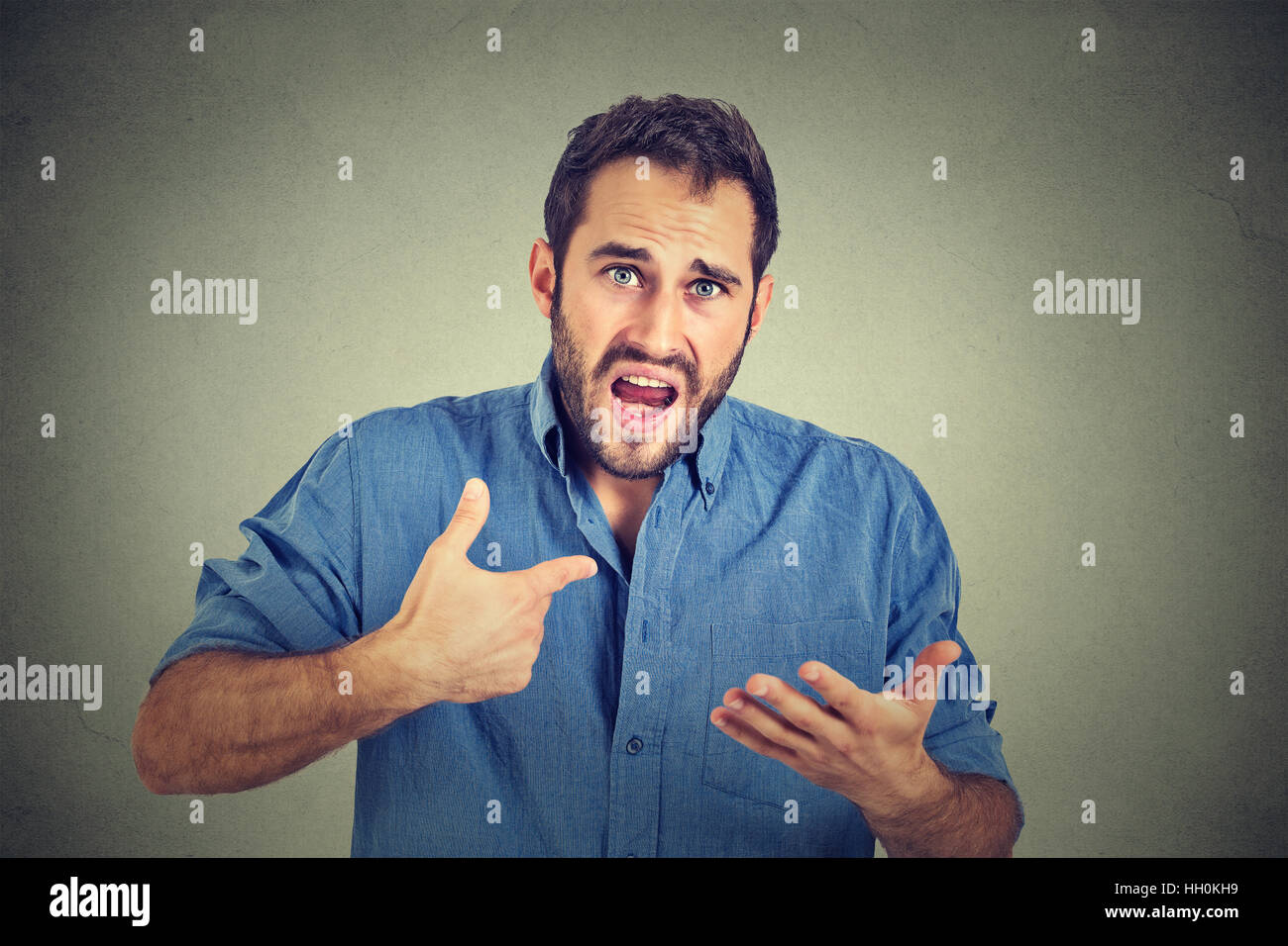 angry, mad, unhappy guy pointing at himself asking you mean me, you ...