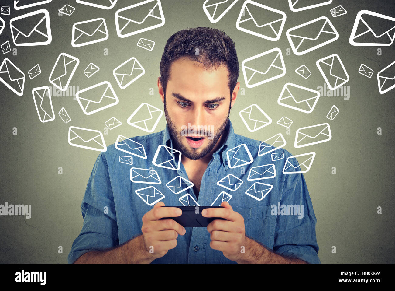 Closeup portrait young shocked man busy sending messages emails from ...