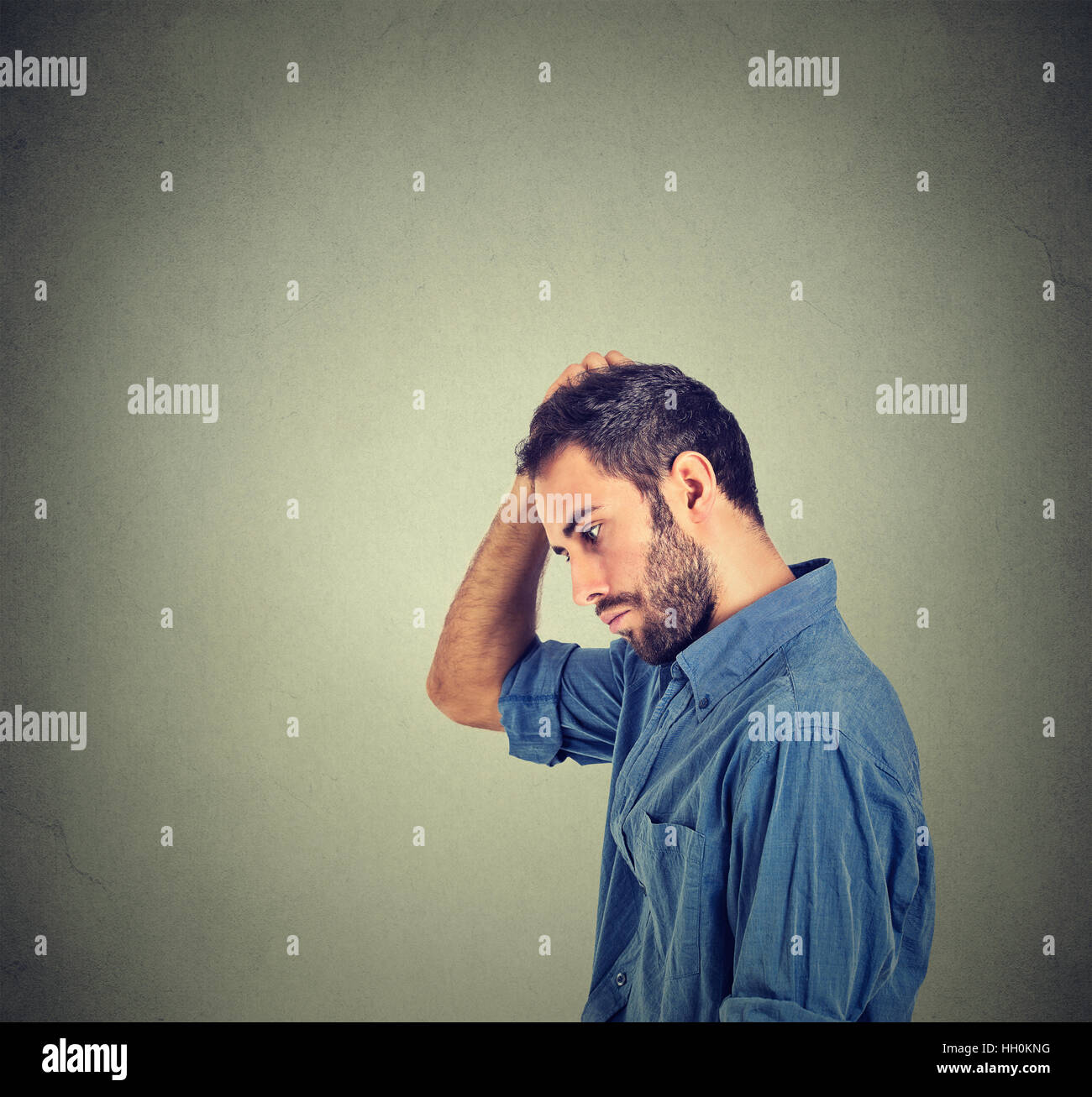 Side profile young thoughtful man isolated on gray wall background with ...