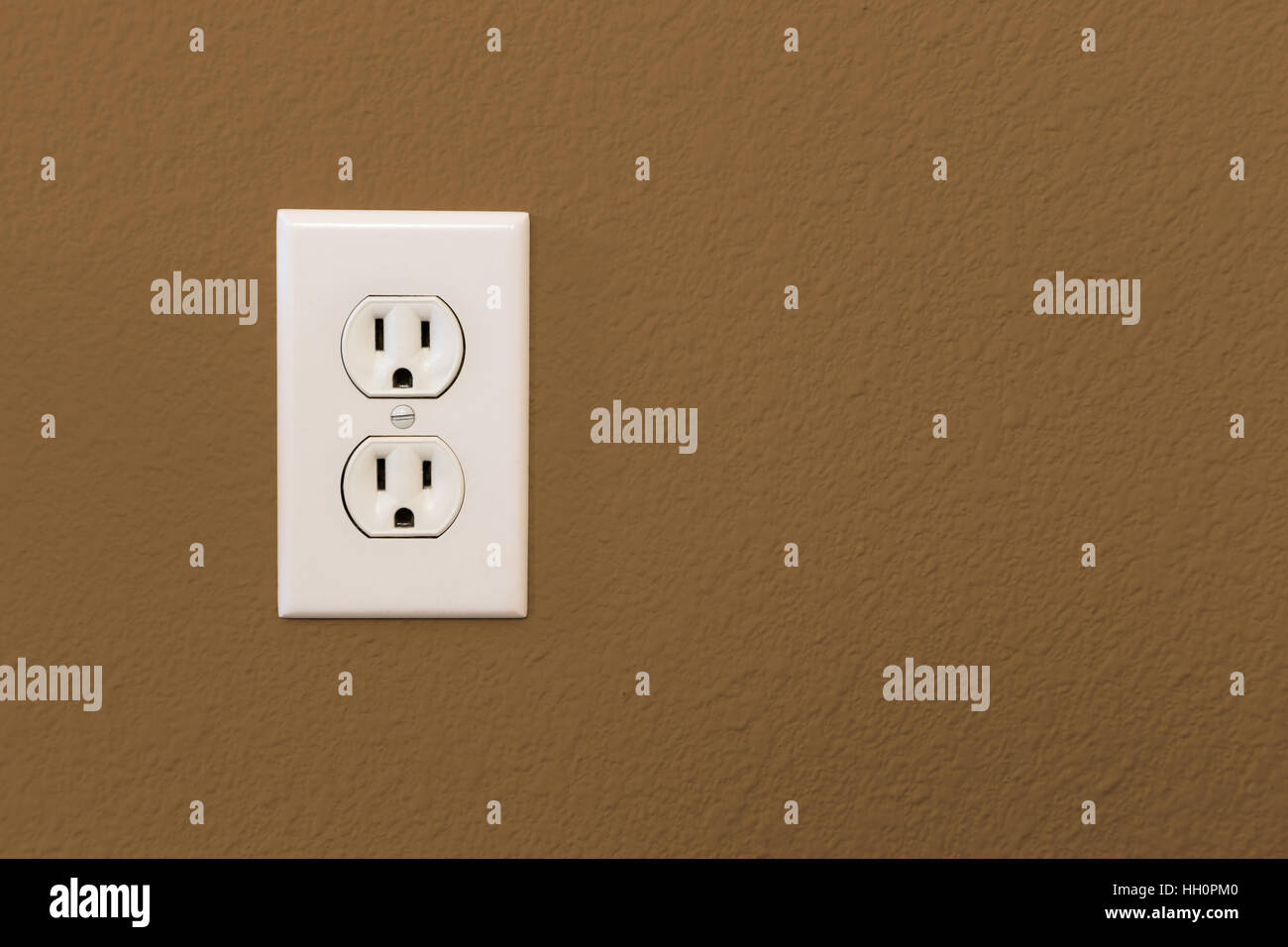 Electrical Sockets In Colorful Brown Wall of House Stock Photo - Alamy