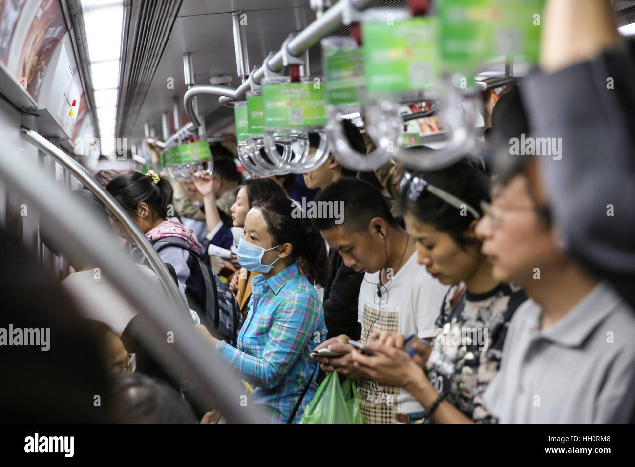Chinese commuters packed into a subway train carriage during rush hour ...