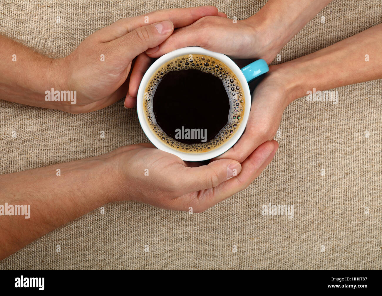 Man and woman hands holding and hugging together big full cup of black ...