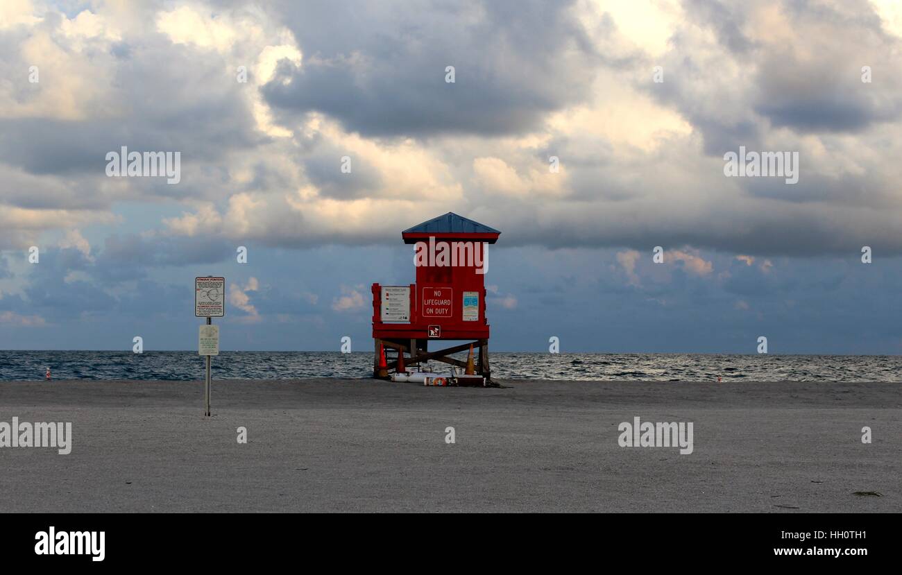 The lifeguard stand with the ocean and the clouds in the background ...