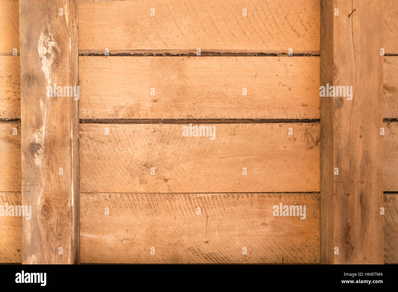 Wooden boards inside an old outbuilding with beams and horizontal ...