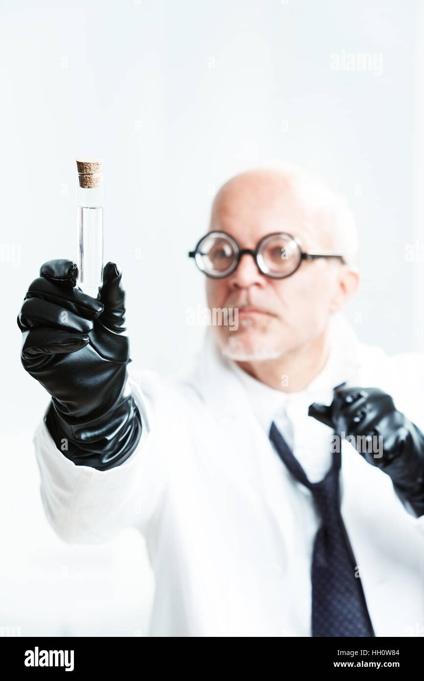 crazy professor or mad doctor staring a mysterious chemical substance ...