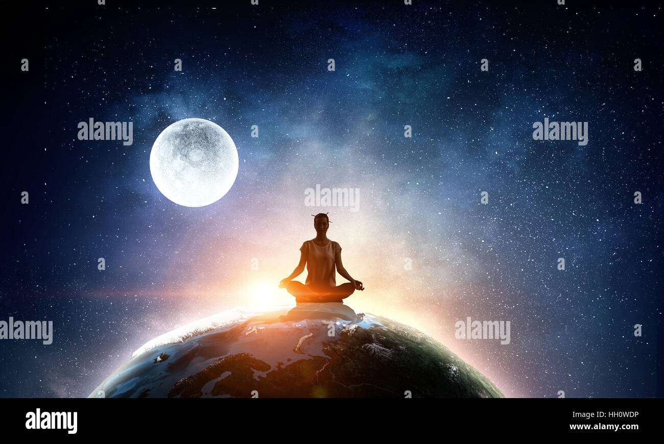 Young woman sitting on Earth planet and meditating. Elements of this ...