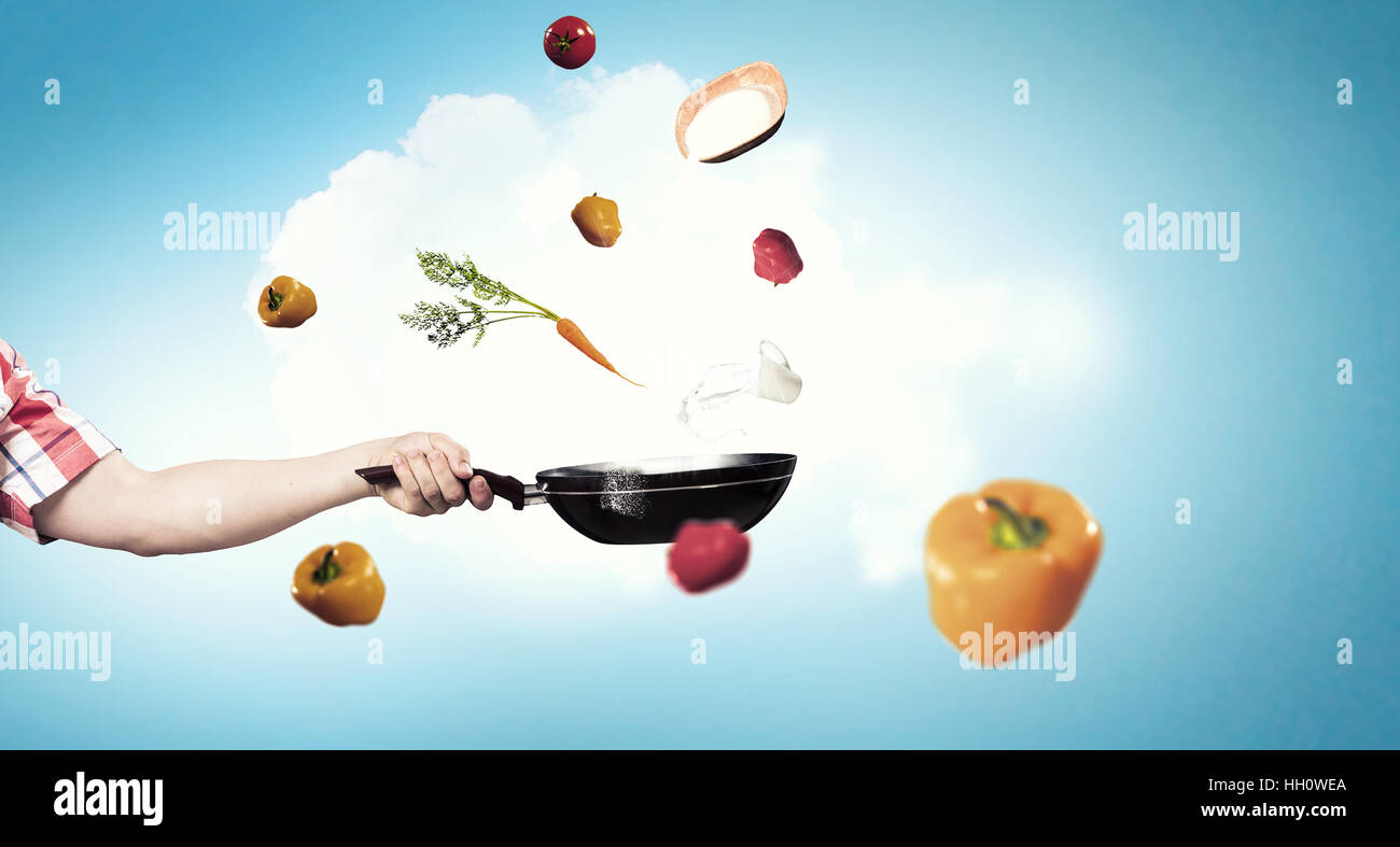 Person hand holding frying pan on white background Stock Photo - Alamy