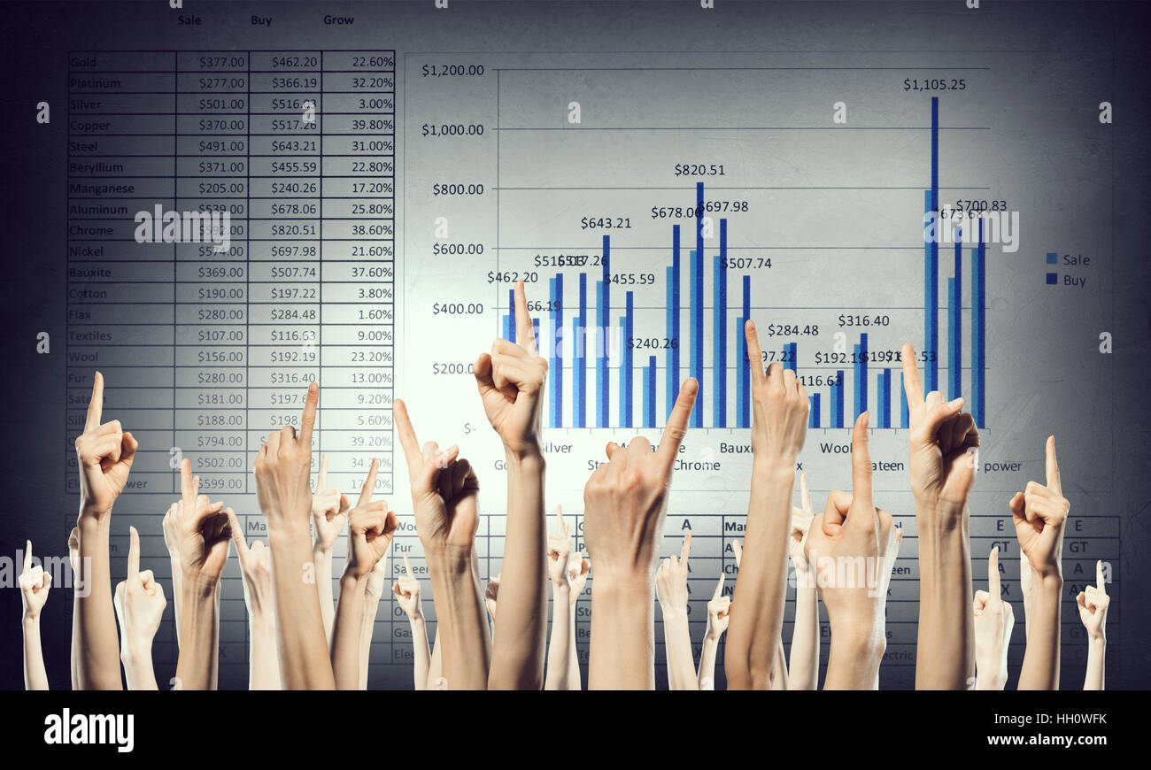Row of raised hands showing different gestures and graphs at background ...