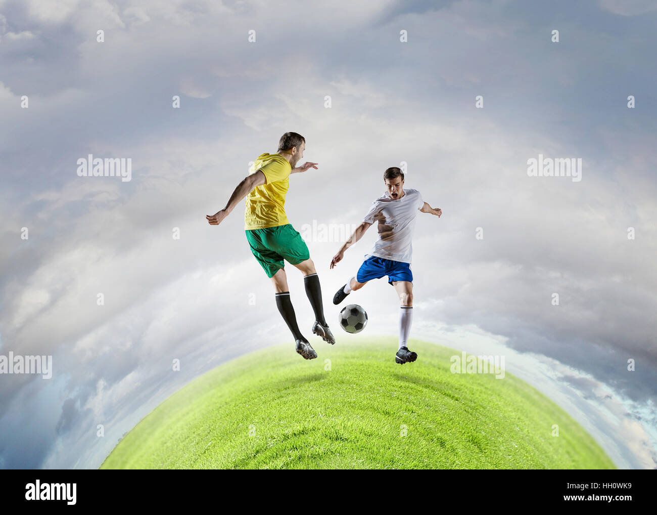 Soccer player with ball in action at natural landscape Stock Photo - Alamy