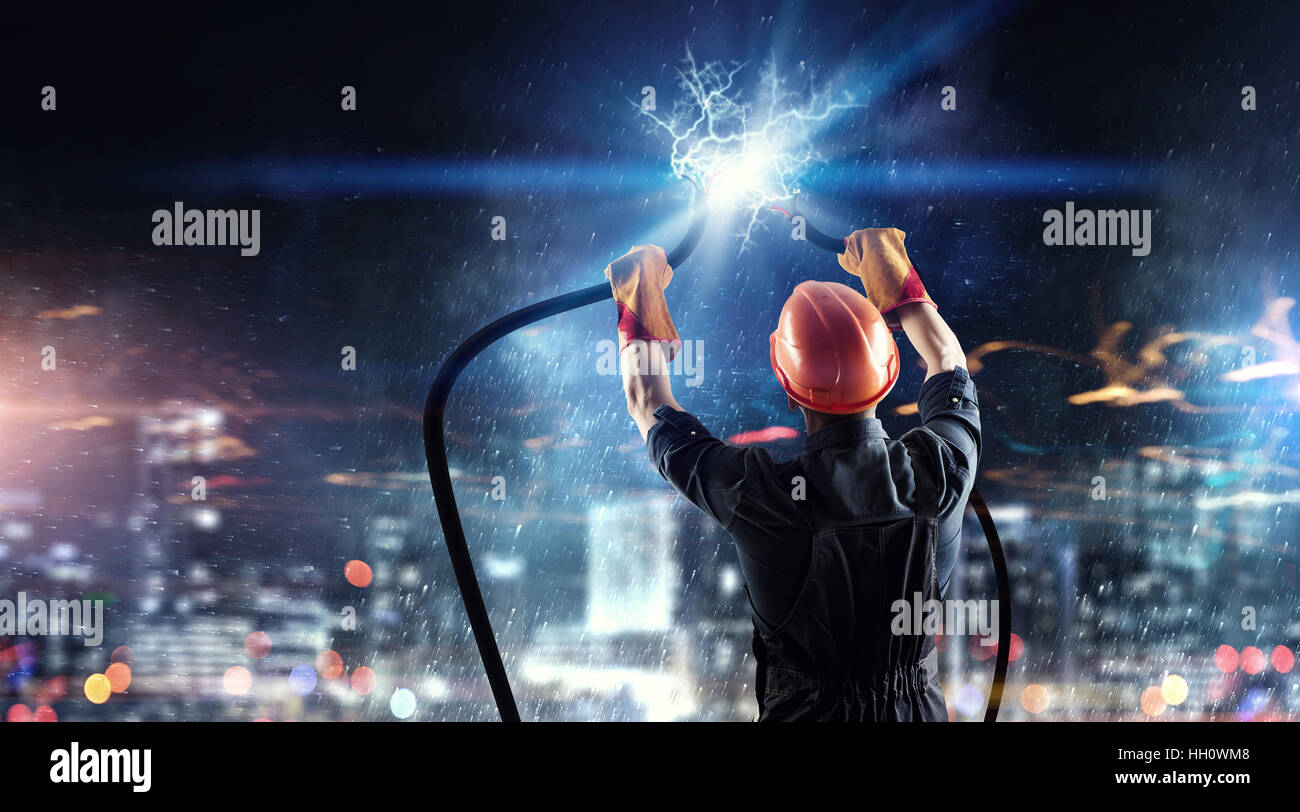 Electrician man joining cable presenting power and energy concept Stock ...